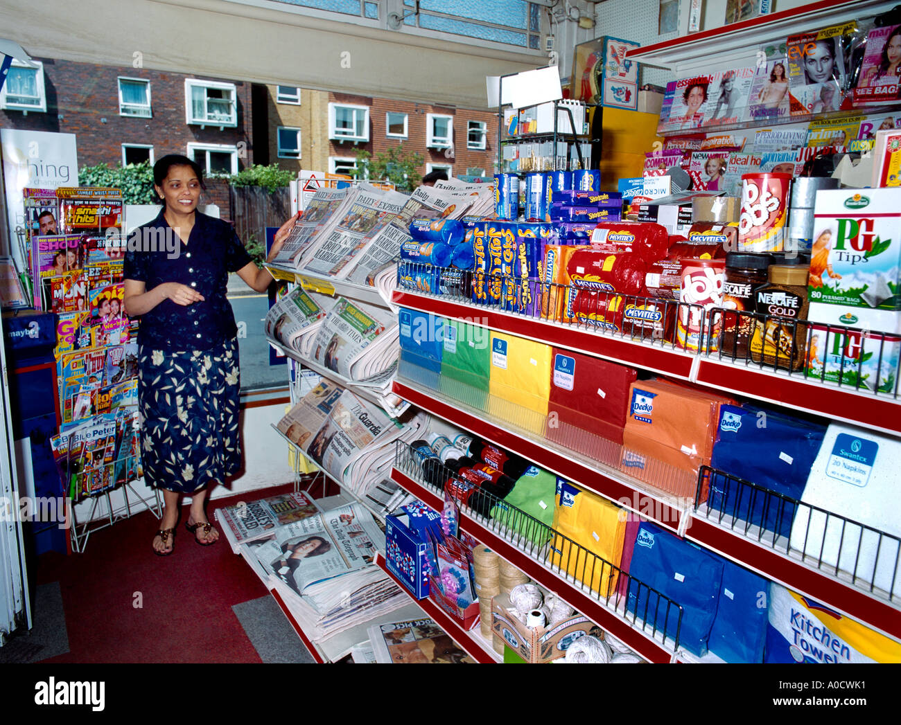 Newsagent Woman Filling Shelf Newspapers Stock Photo - Alamy
