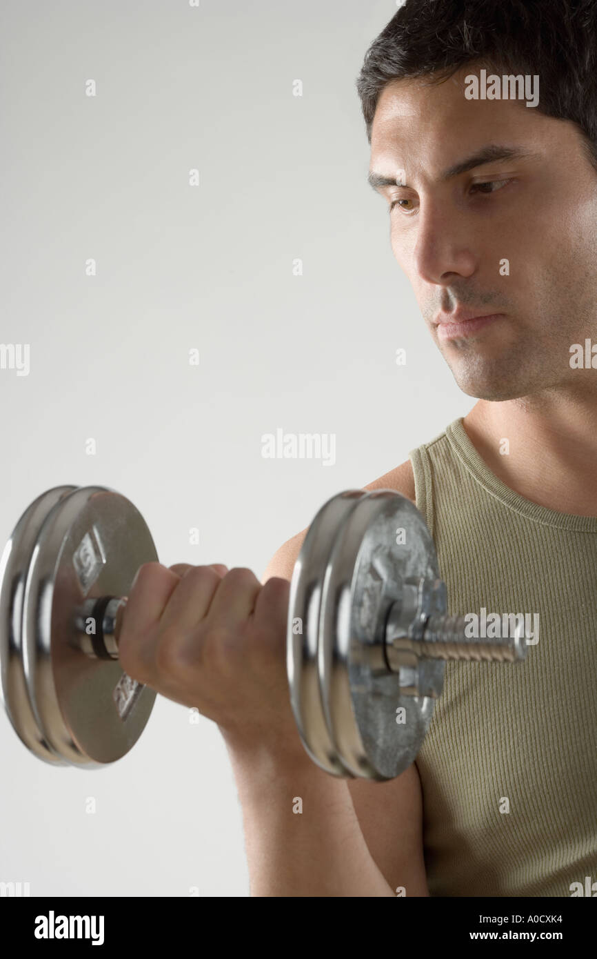 Man using free weights Stock Photo - Alamy