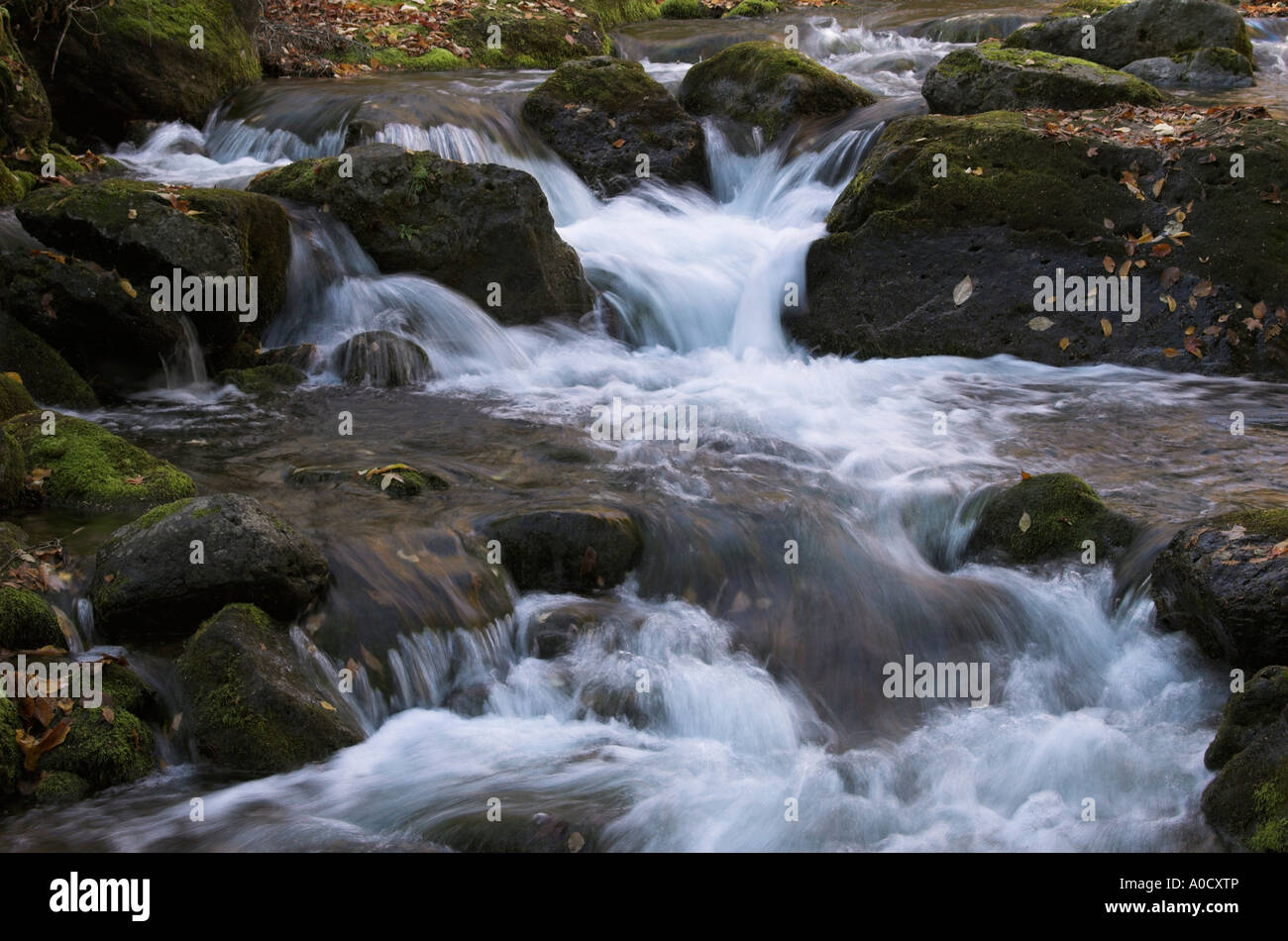 river water flowing around rocks Stock Photo - Alamy