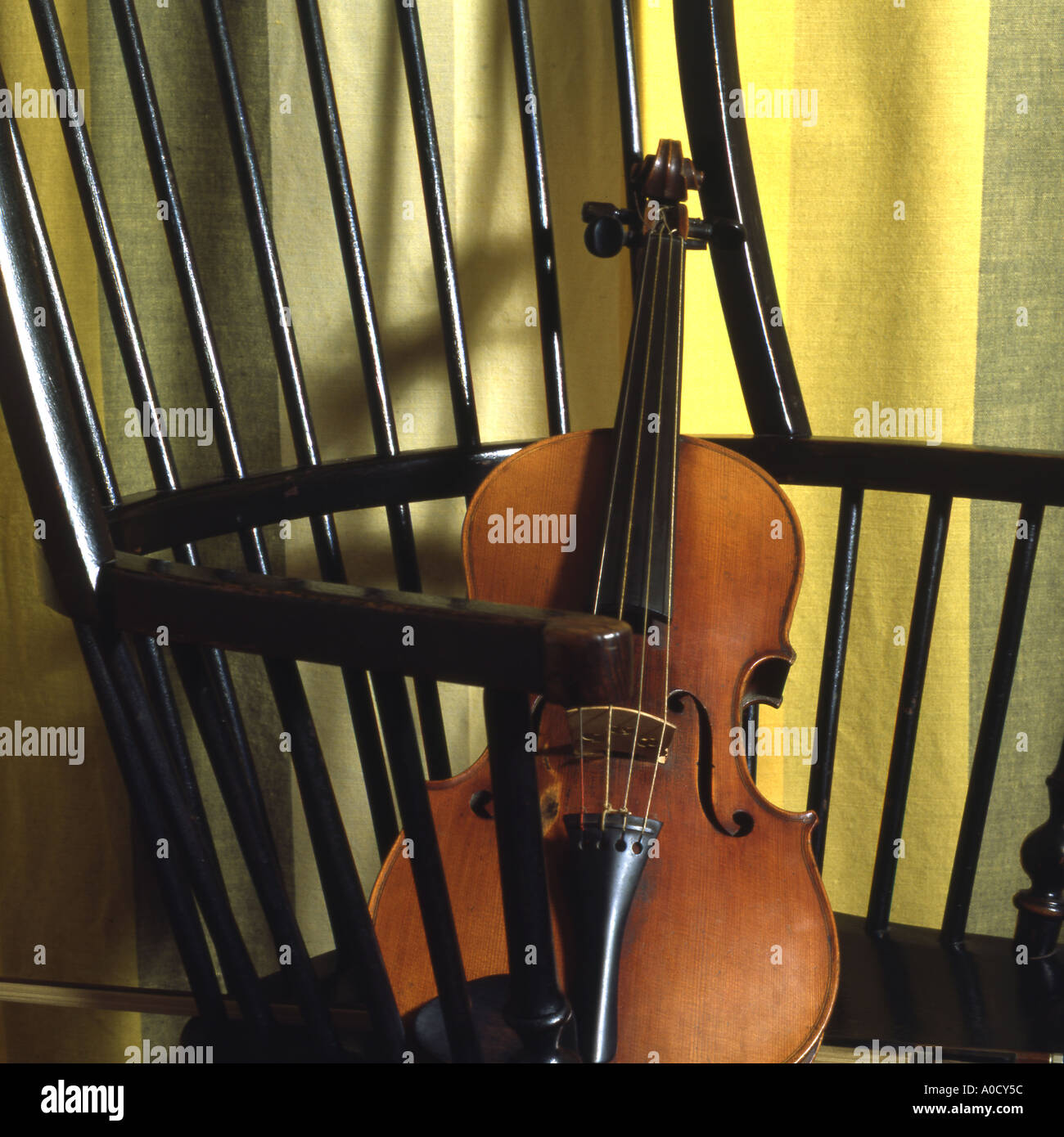 Fiddle Resting on an Old Chair Stock Photo - Alamy