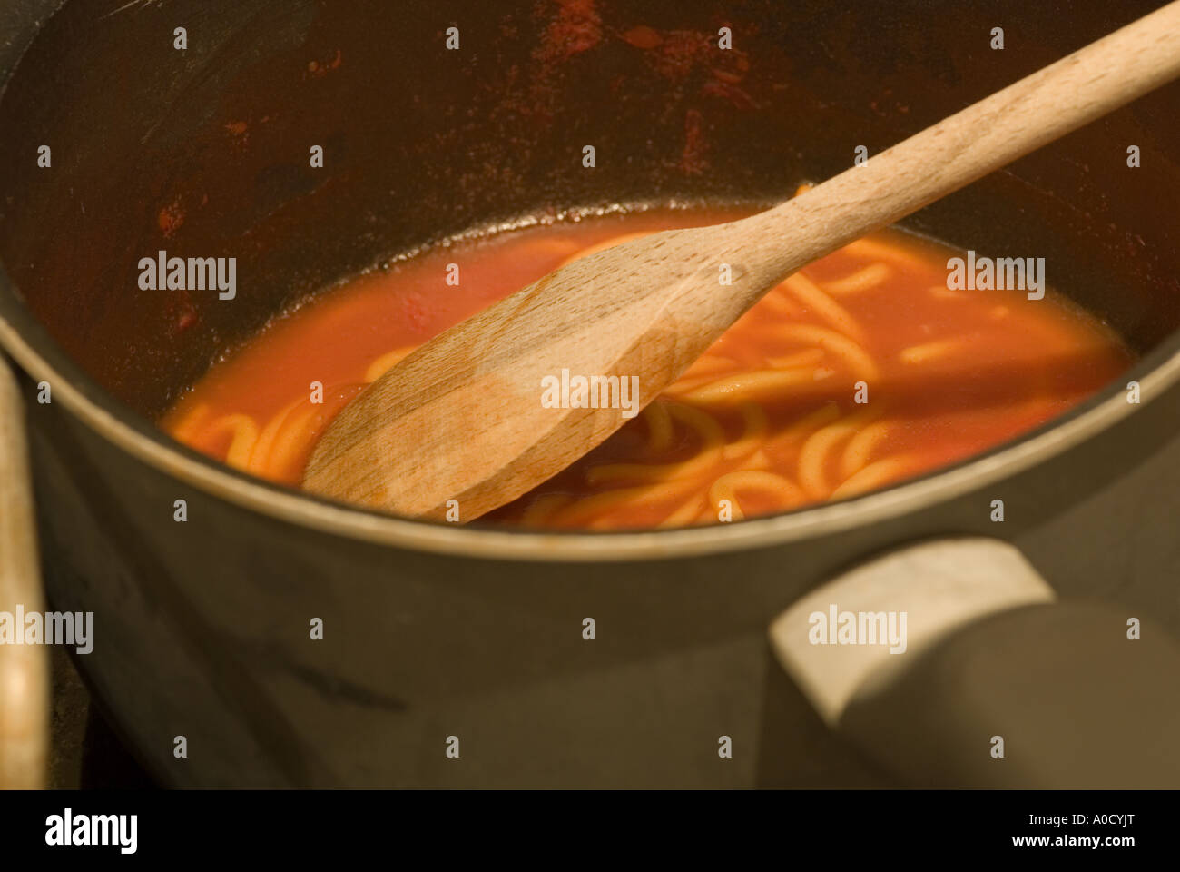Cooking tinned spaghetti in a pan Stock Photo - Alamy