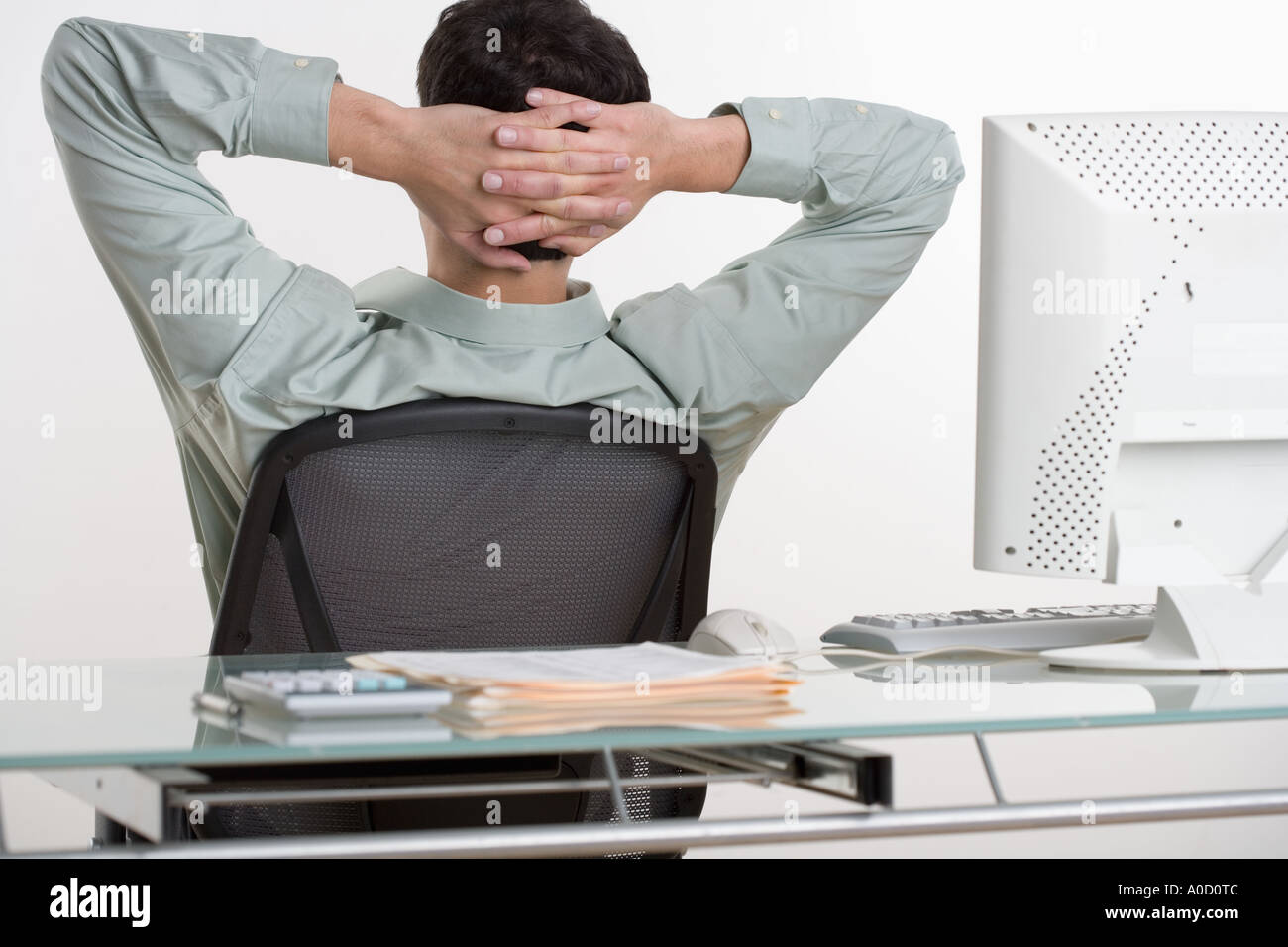 Man relaxing at his desk Stock Photo - Alamy