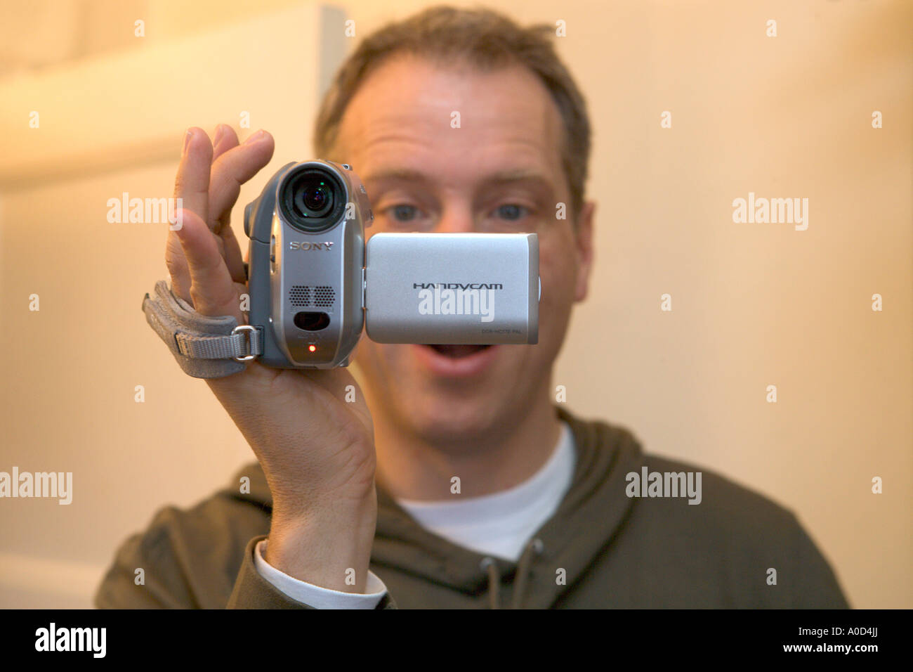 MAN FILMING WITH VIDEO CAMERA Stock Photo - Alamy