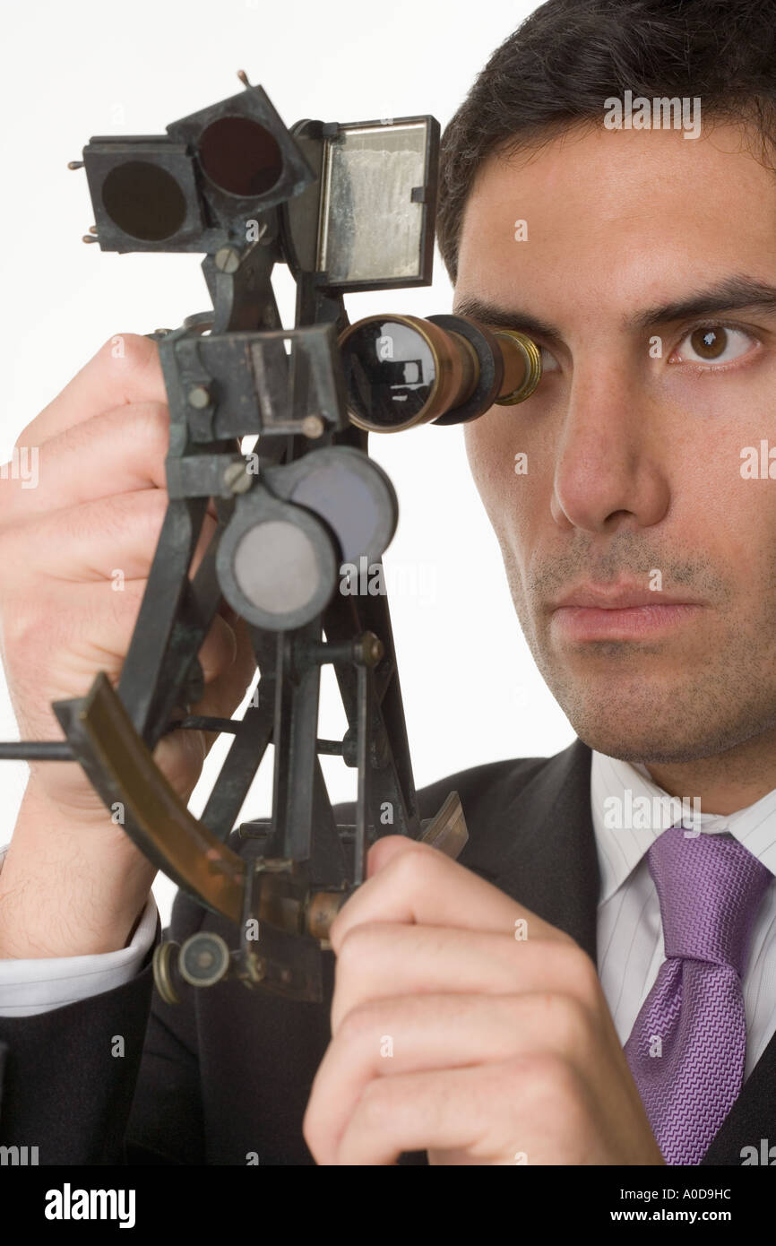 Man holding a sextant Stock Photo - Alamy