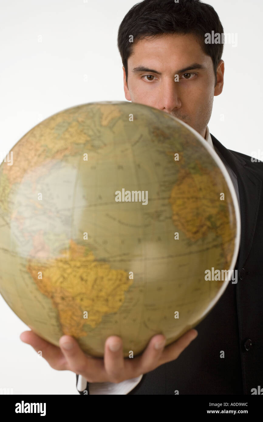 Man holding globe Stock Photo - Alamy