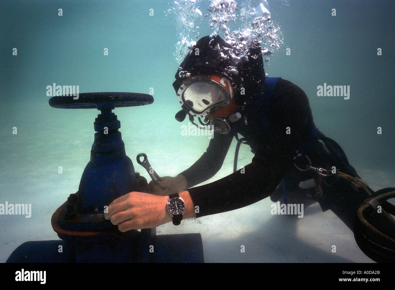 commercial oil rig diver at work underwater on valve in north sea Stock ...