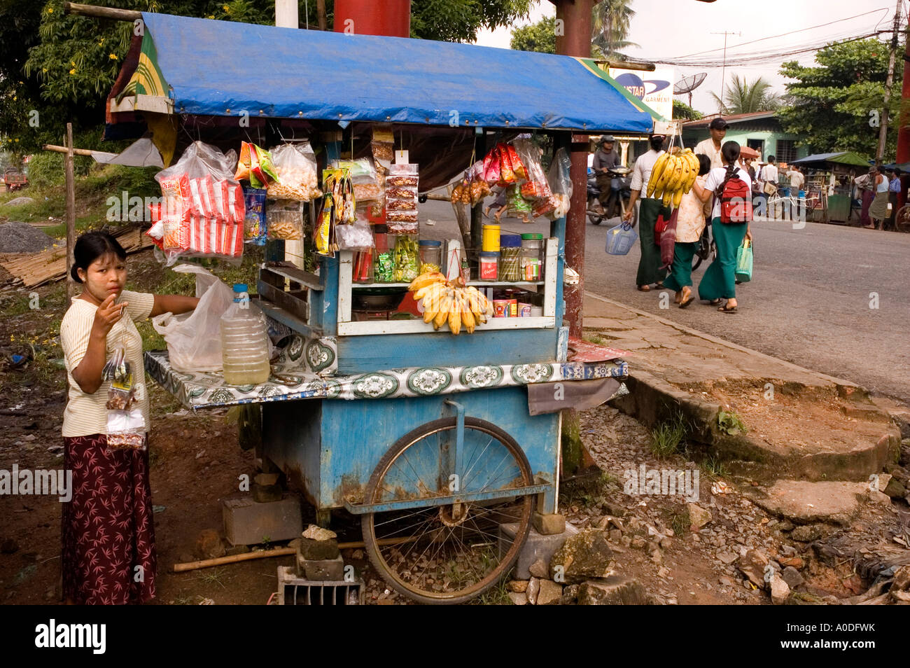 Stock photograph of a woman with her snack and small goods cart at Bago ...