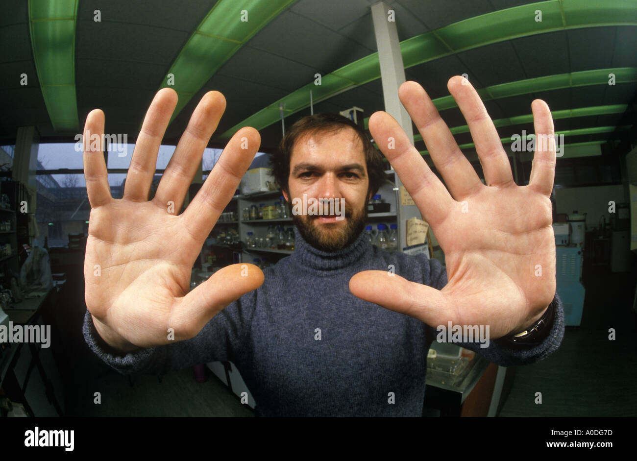 Professor Sir Alec Jeffreys holding up hands to show his hands to show ...
