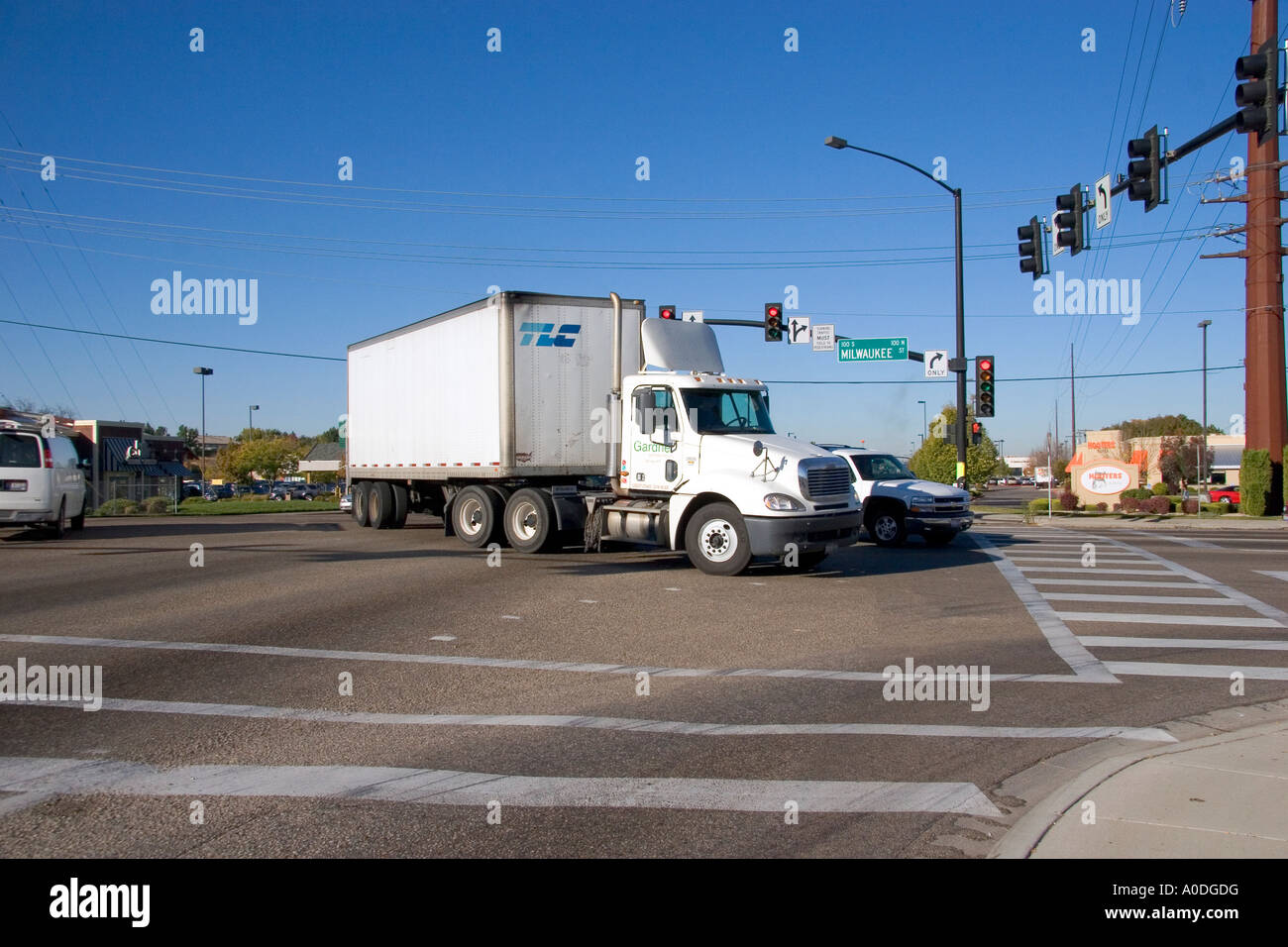 A delivery truck in traffic making a left turn at an intersection in ...