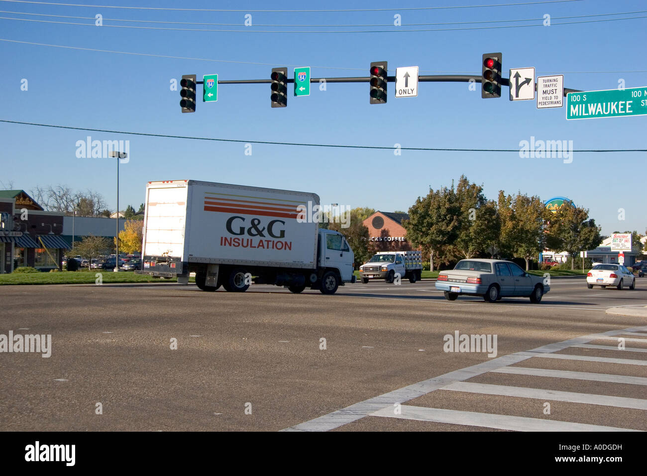A delivery truck in traffic turning left at an intersection in Boise ...