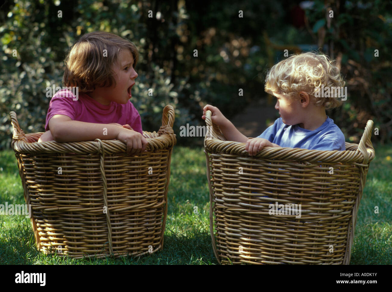 two children in baskets Stock Photo - Alamy