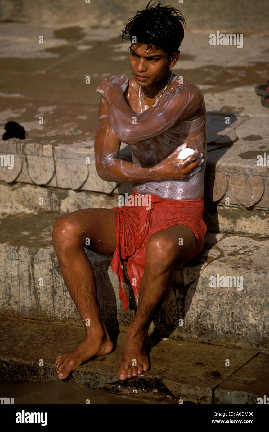 Indian young man washing in the sacred Ganges River Varanasi Uttar ...