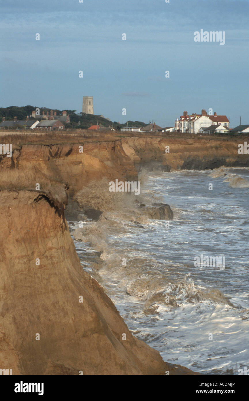 A view of a high tide battering and eroding soft cliffs in North ...