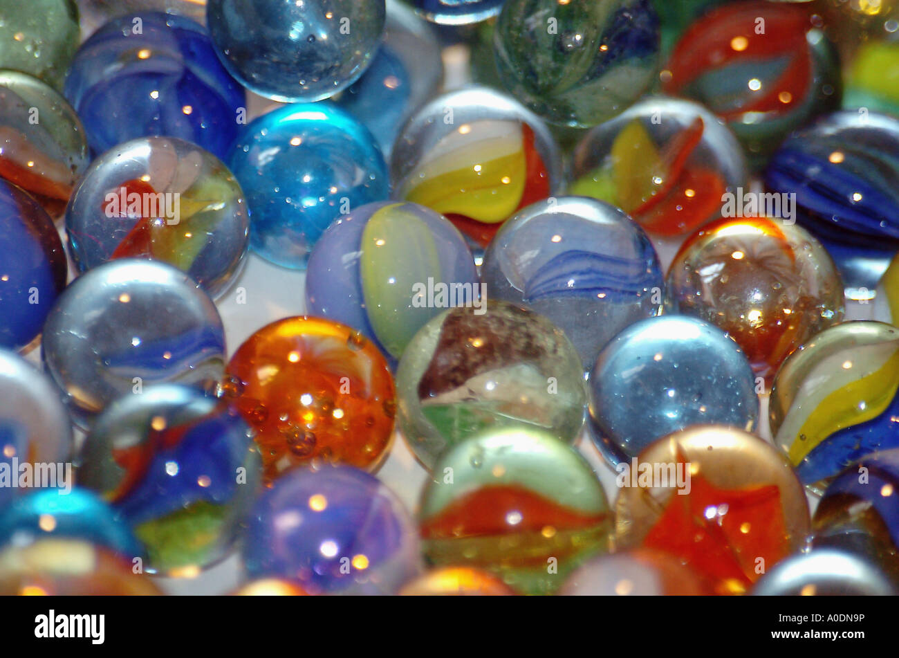 A close up shot reveals the shiny irridescence of individual marbles ...