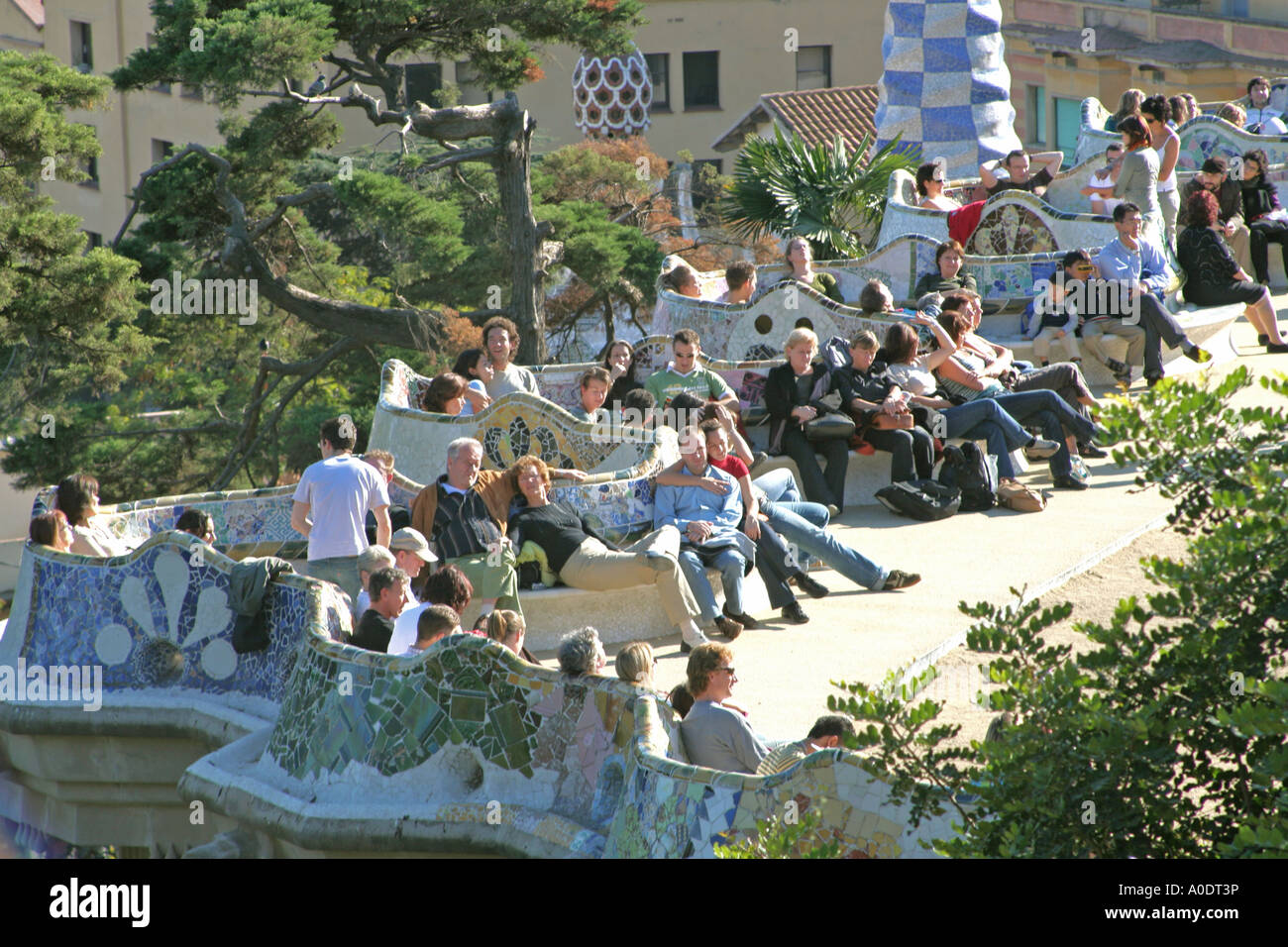 Hordes of visitors enjoying a sunny day at snake benches Antoni Gaudi`s ...