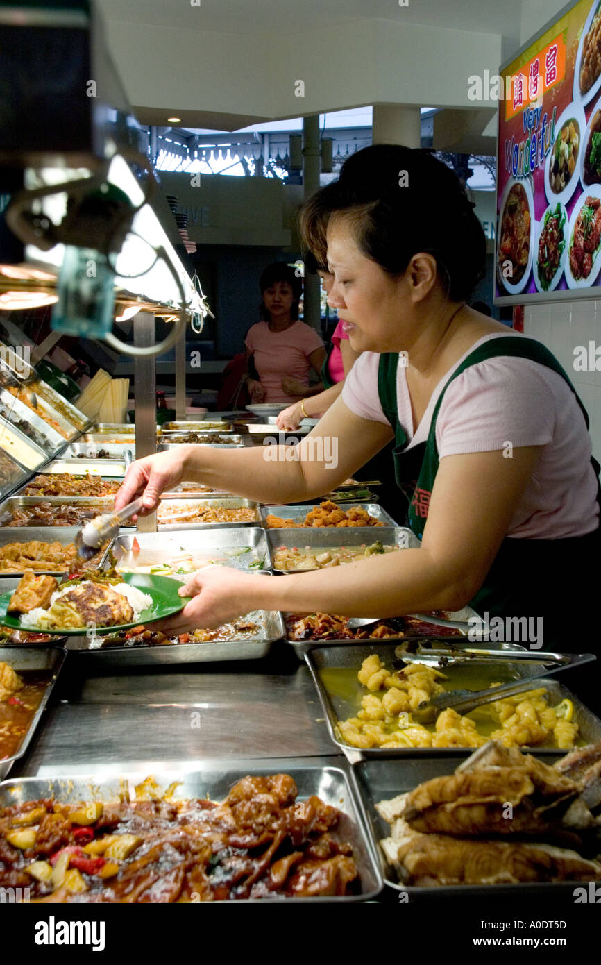 Woman working at a food counter in Singapore s most spectacular Hawker ...