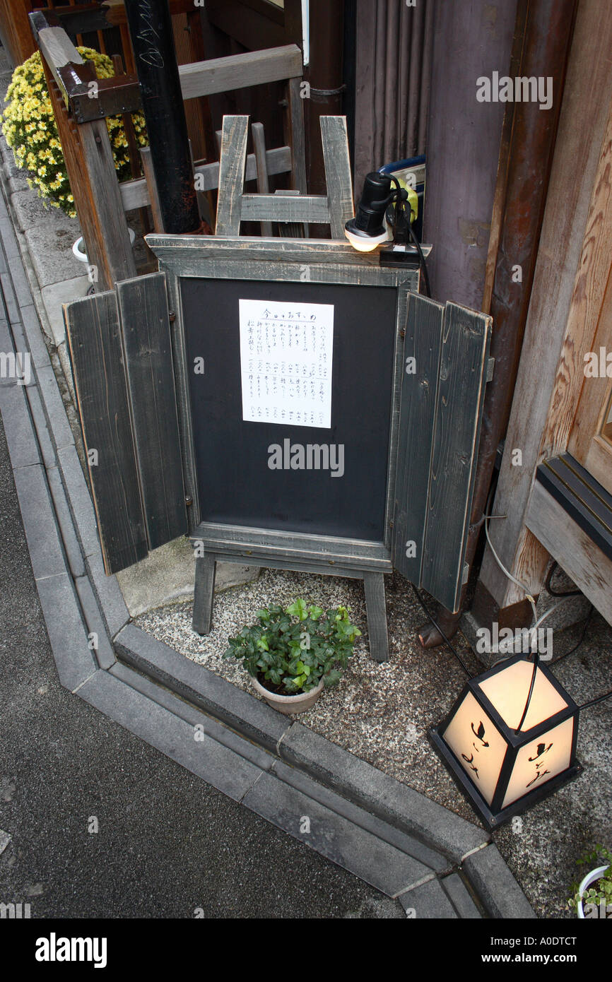 A menu board standing outside a traditional restaurant in the Ponto cho ...