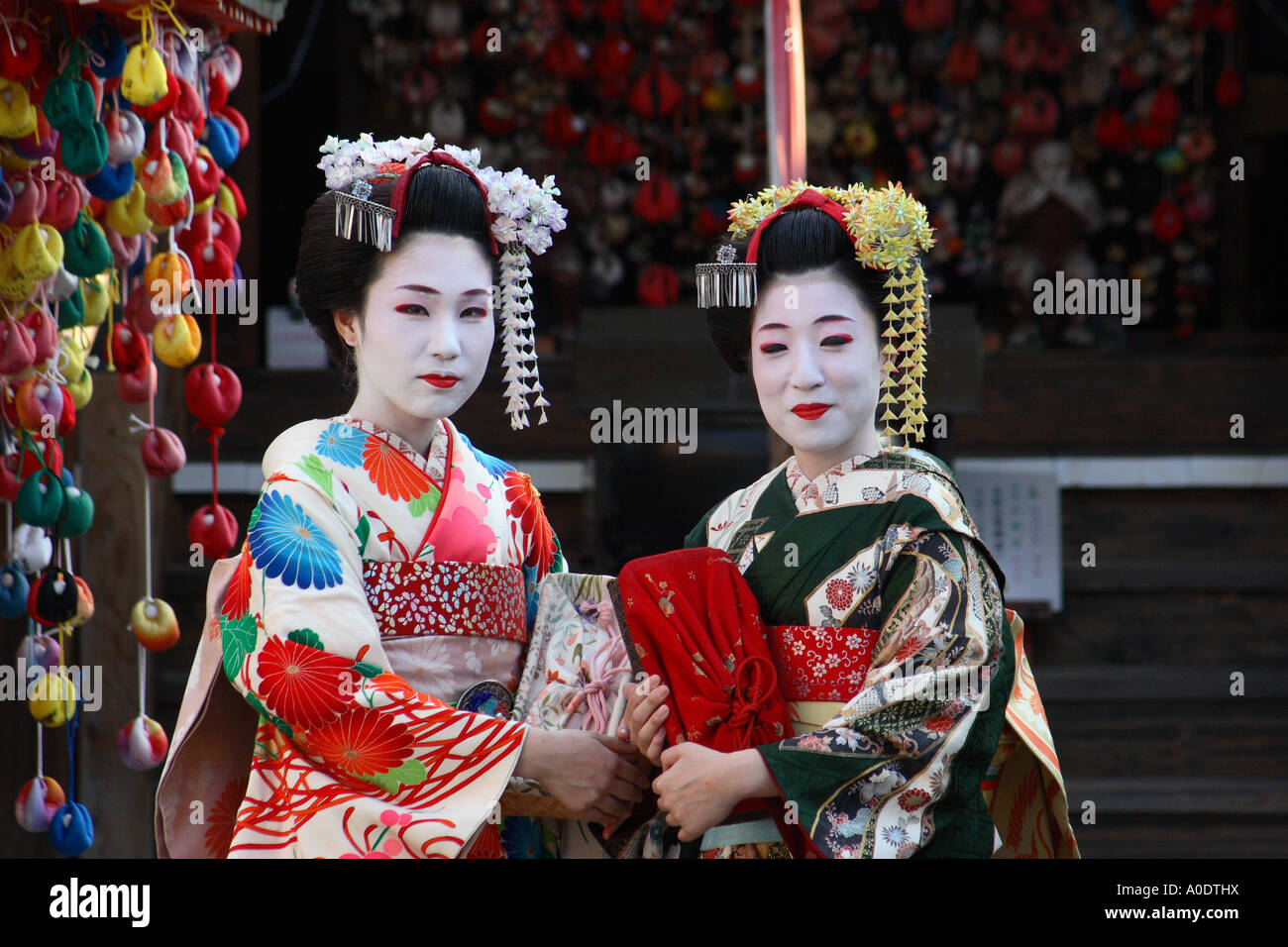 Two maiko - apprentice geisha - visit a shrine in the historic Gion ...