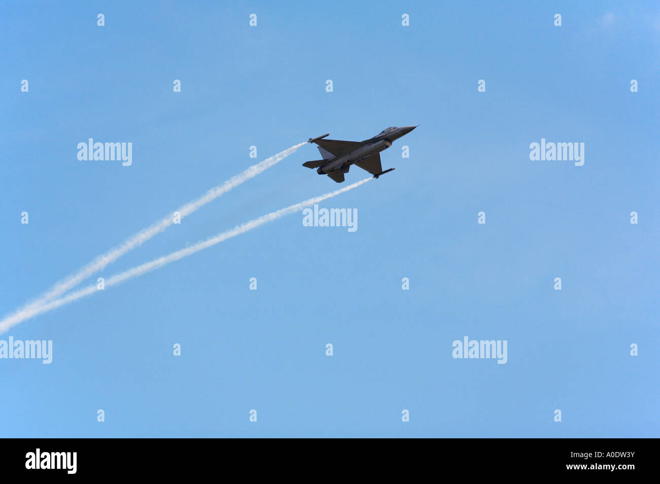 Belgian Airforce F16 Fighting Falcon laying smoke trails to simulate ...