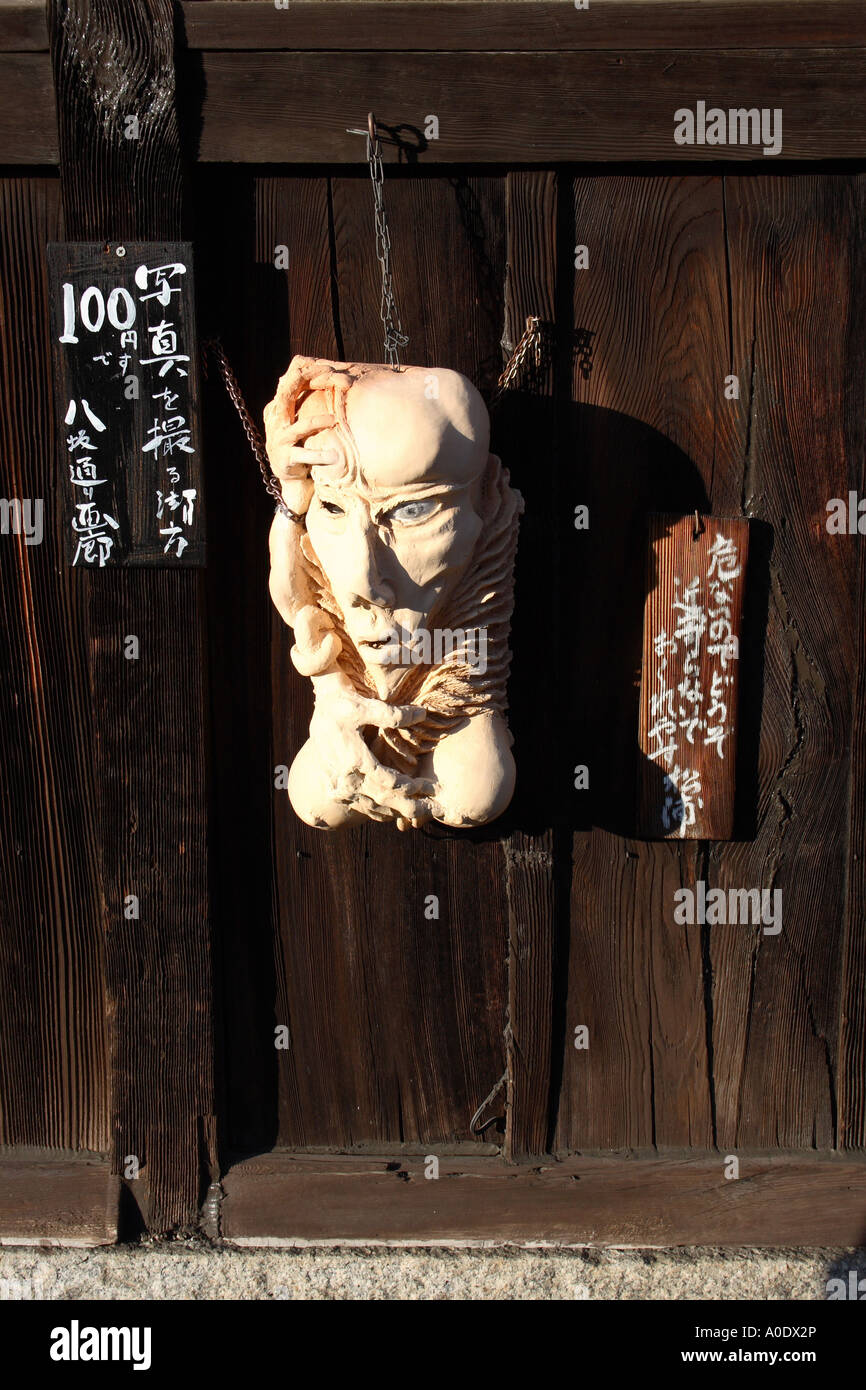 A grotesque figure hanging outside an artist's studio in the temple ...