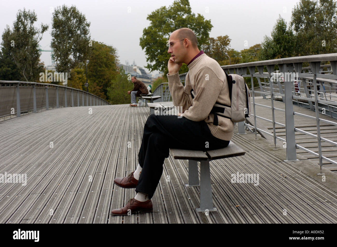 Sitting man speaking over mobile phone Stock Photo - Alamy