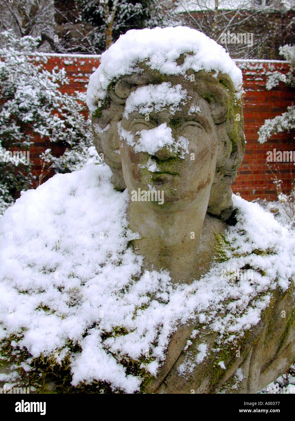 garden statue ornament bust in snow Stock Photo - Alamy