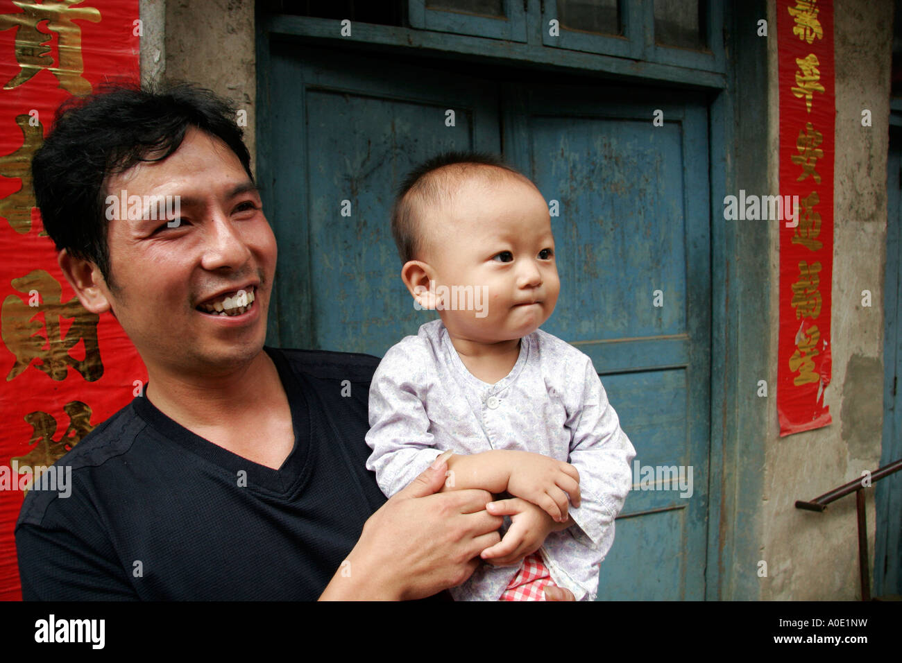 Proud father with his baby, Southwest China Stock Photo - Alamy