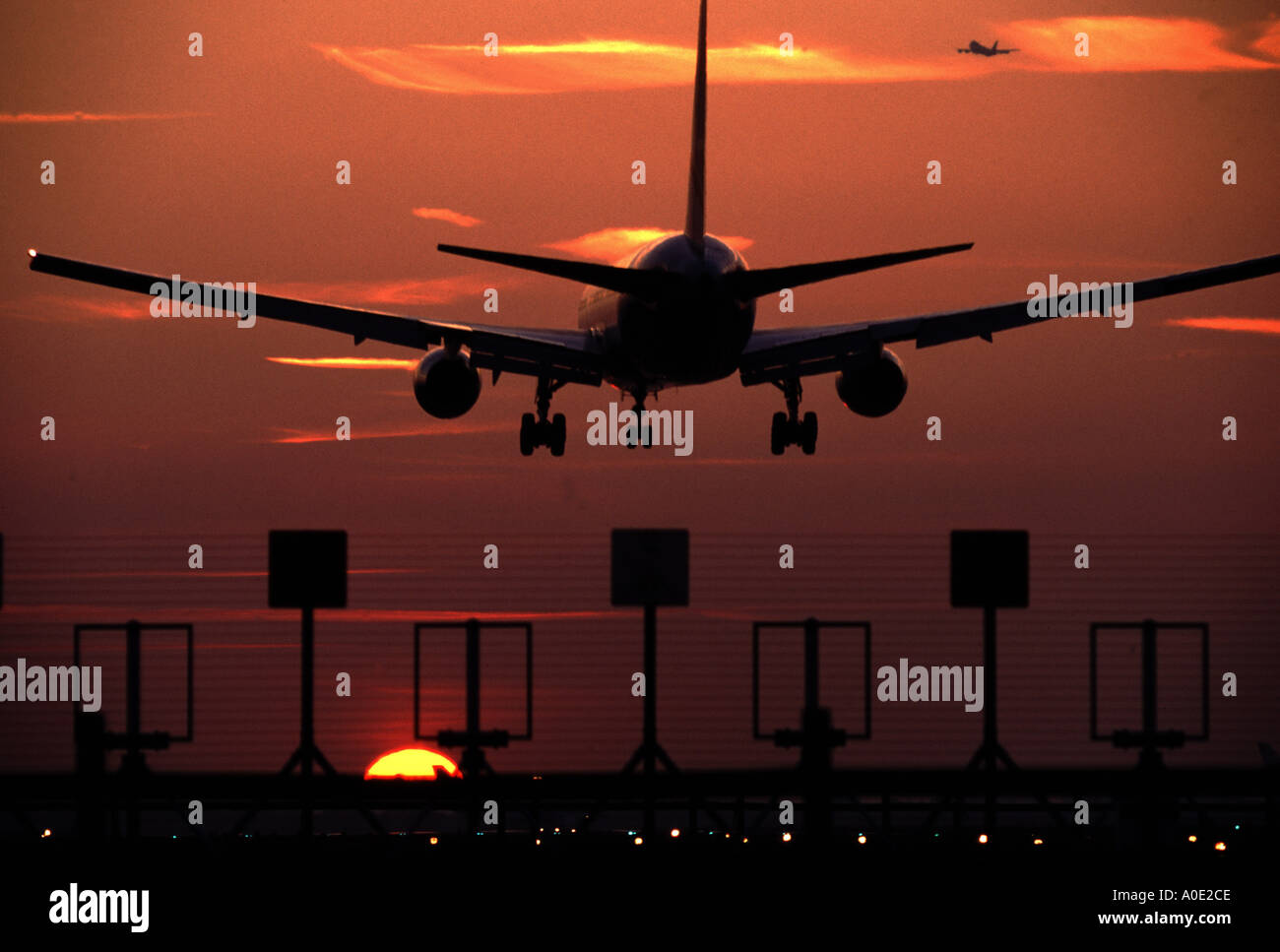 Aircraft landing in sunset Stock Photo - Alamy