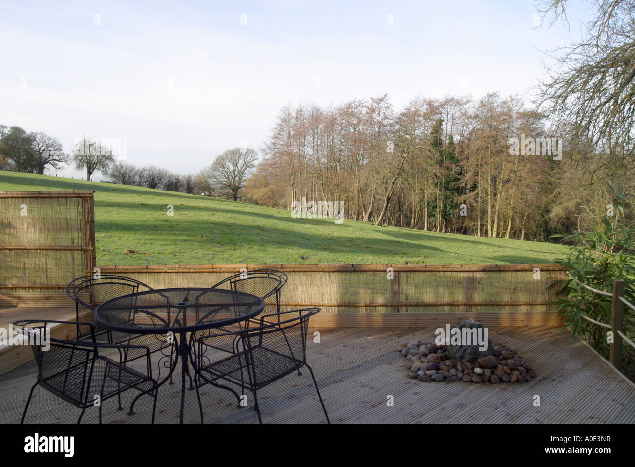 UK garden patio terrace with table and chairs and a view over open ...