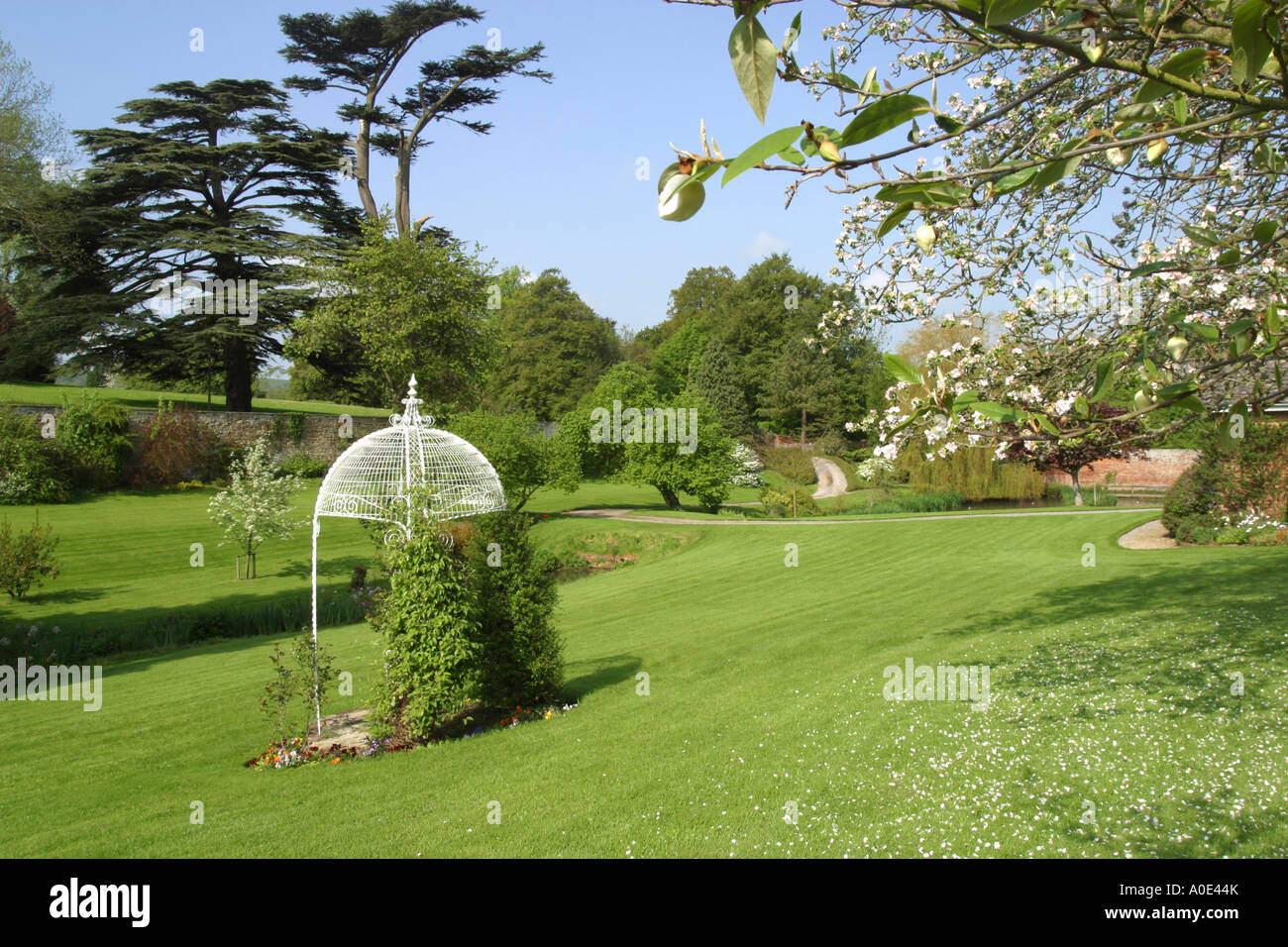 Large manicured lawned UK garden with trees, shrubs and features Stock ...