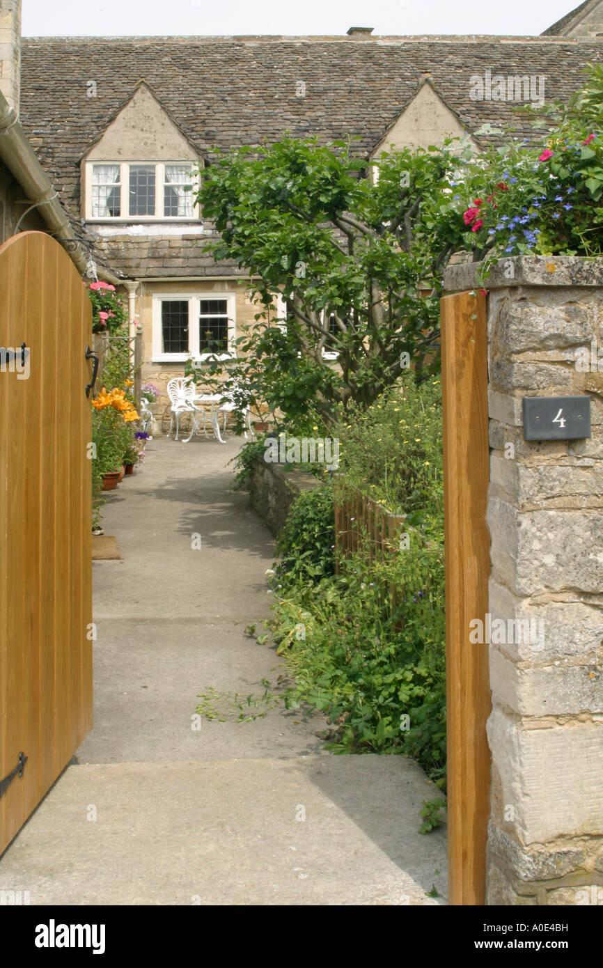Open garden gate leading to front door of stone cottage Stock Photo - Alamy