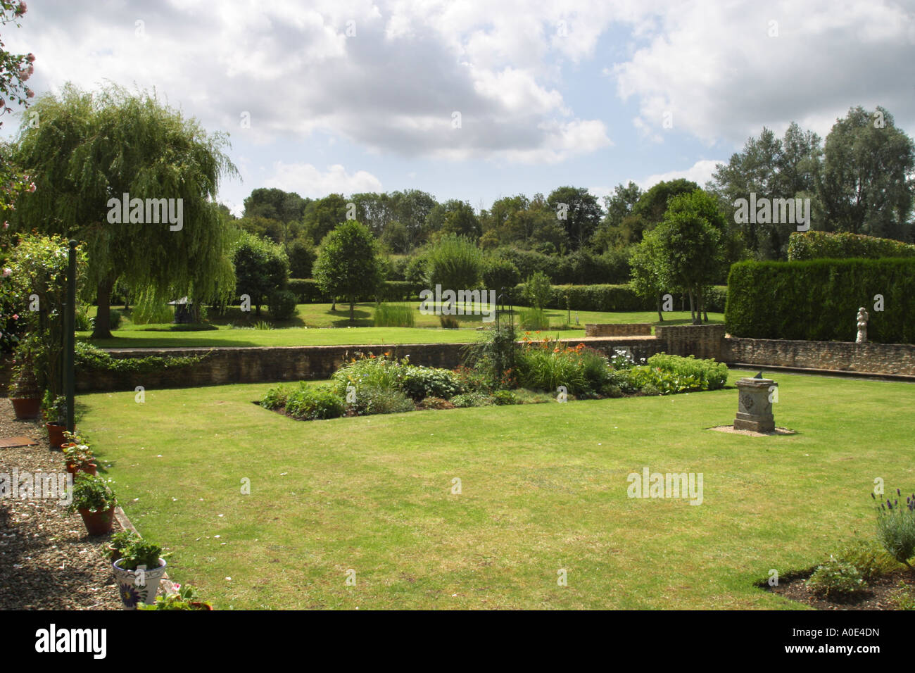 Large formal style lawned UK garden with trees and shrubs Stock Photo ...