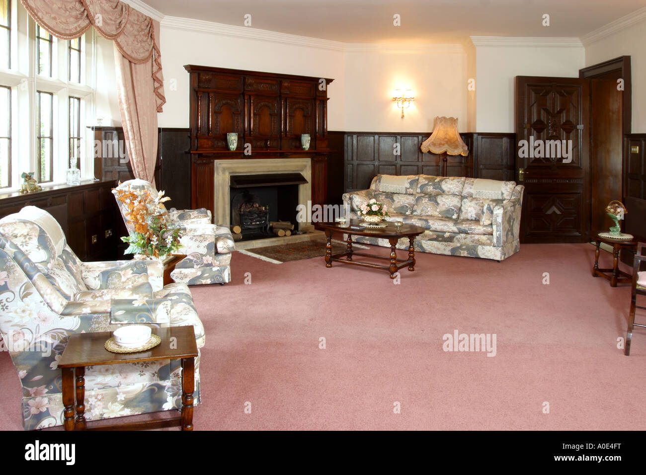 UK property, house interior, sitting room, partly dark wood panelled ...