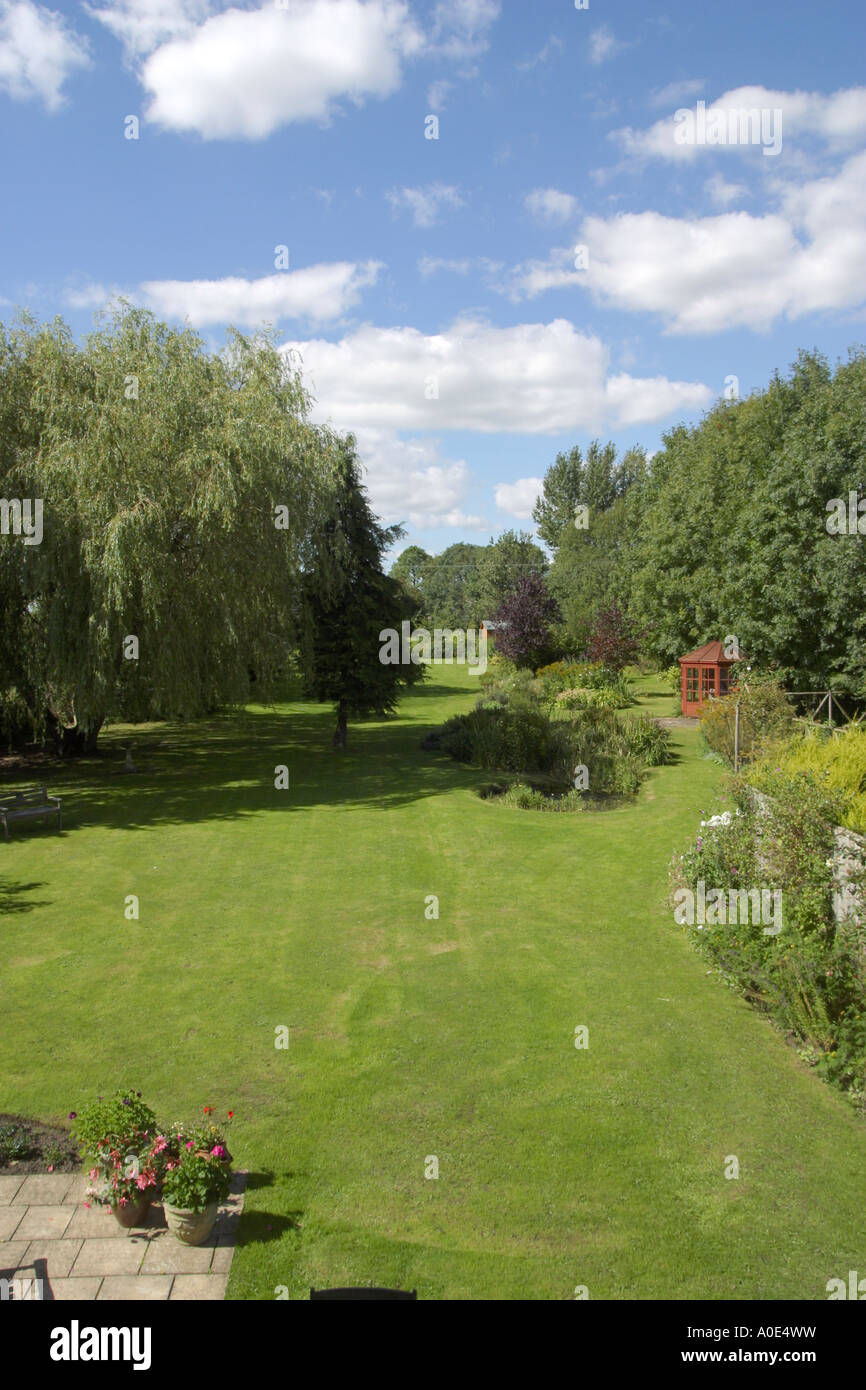 Large mature summer UK garden with trees and shrubs Stock Photo - Alamy