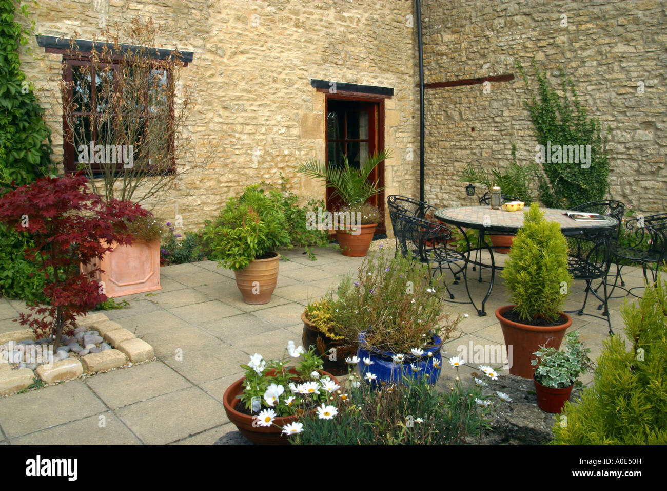 UK garden patio terrace with table and chairs Stock Photo - Alamy