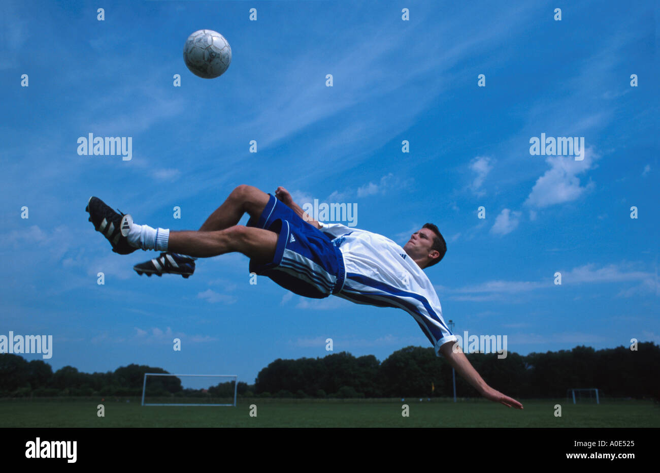 soccer football soccerplayer hitting ball in midair Stock Photo - Alamy