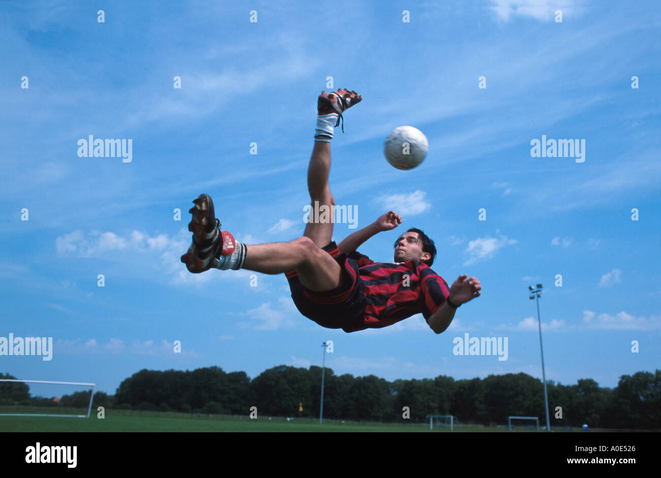 soccer football soccerplayer hitting ball in midair Stock Photo - Alamy