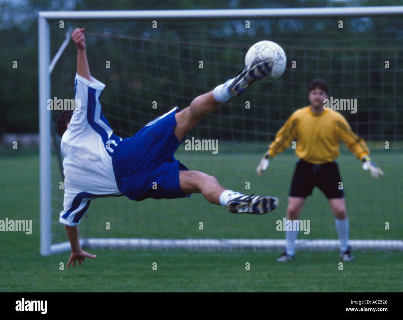 soccer football player striking ball at goal Stock Photo - Alamy