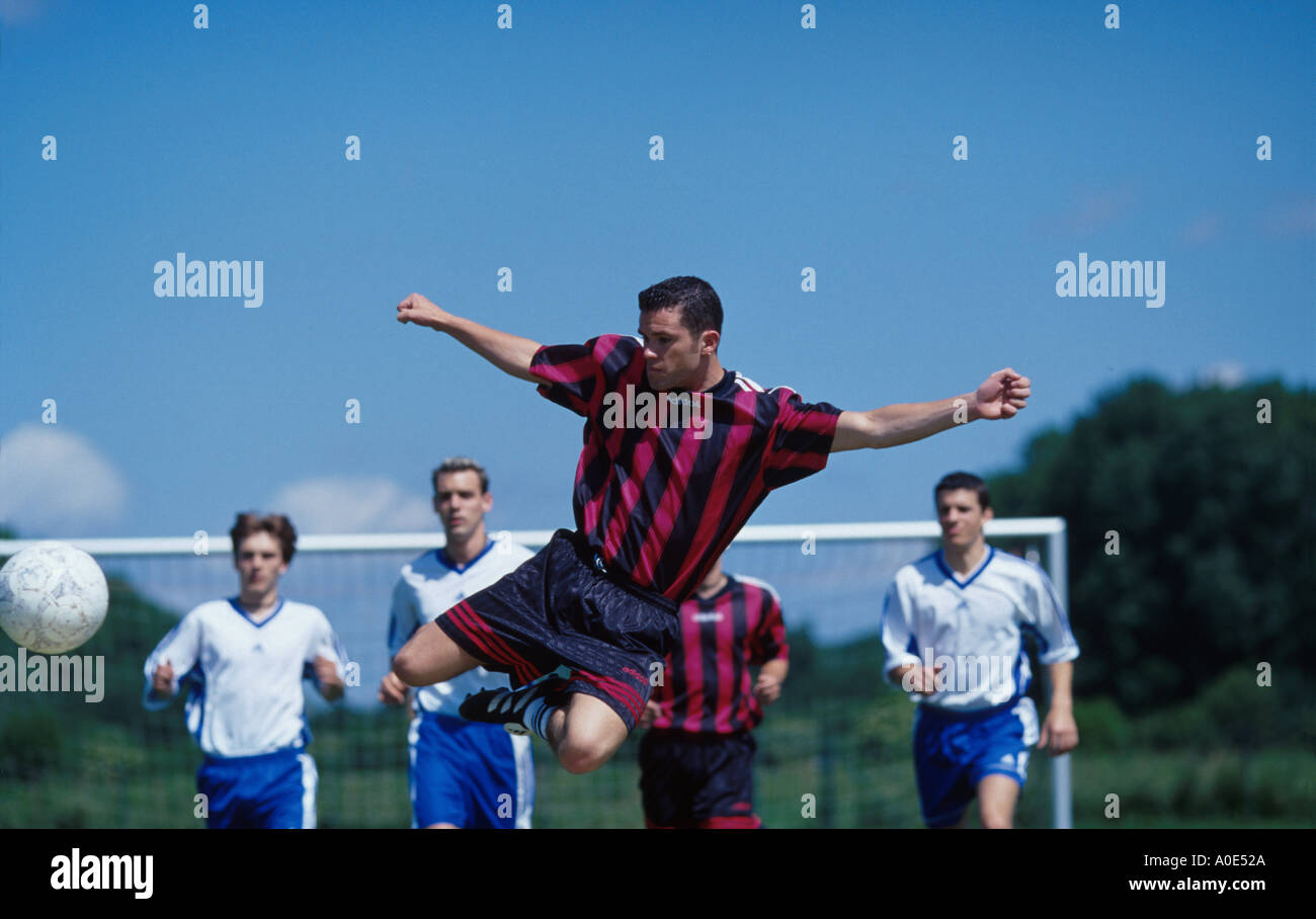 soccer football player striking ball in midair Stock Photo - Alamy