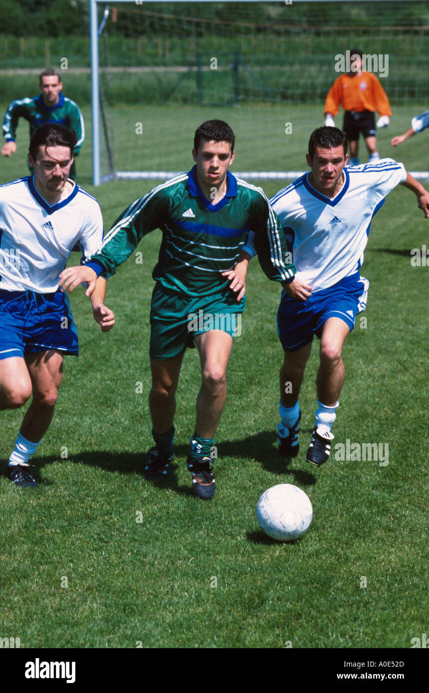 soccer football young men chasing ball Stock Photo - Alamy