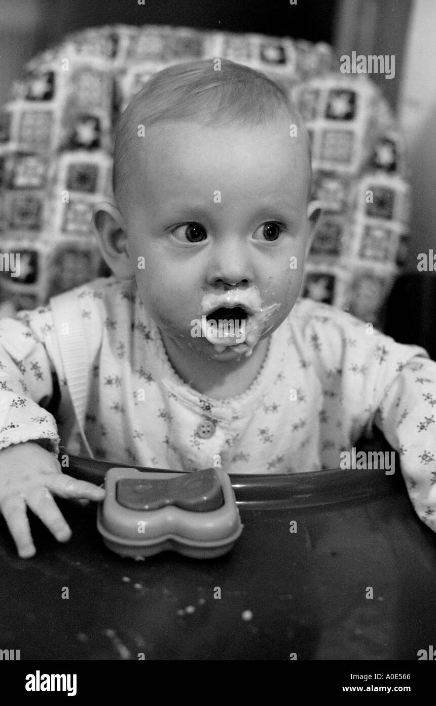 Baby girl eating Stock Photo - Alamy