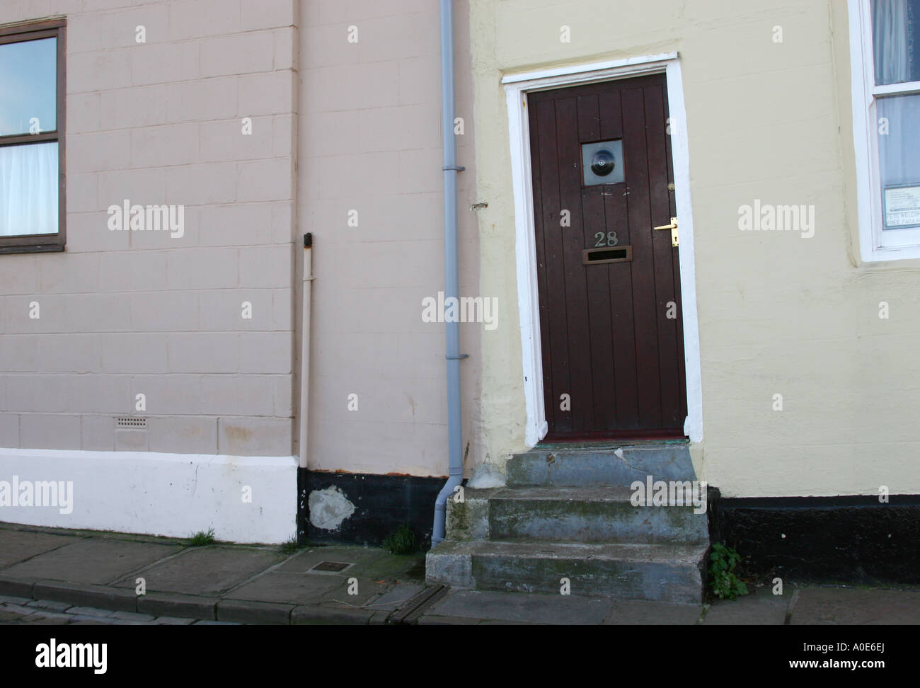 Old cottage on slope in Whitby with door and windows at an angle Stock ...