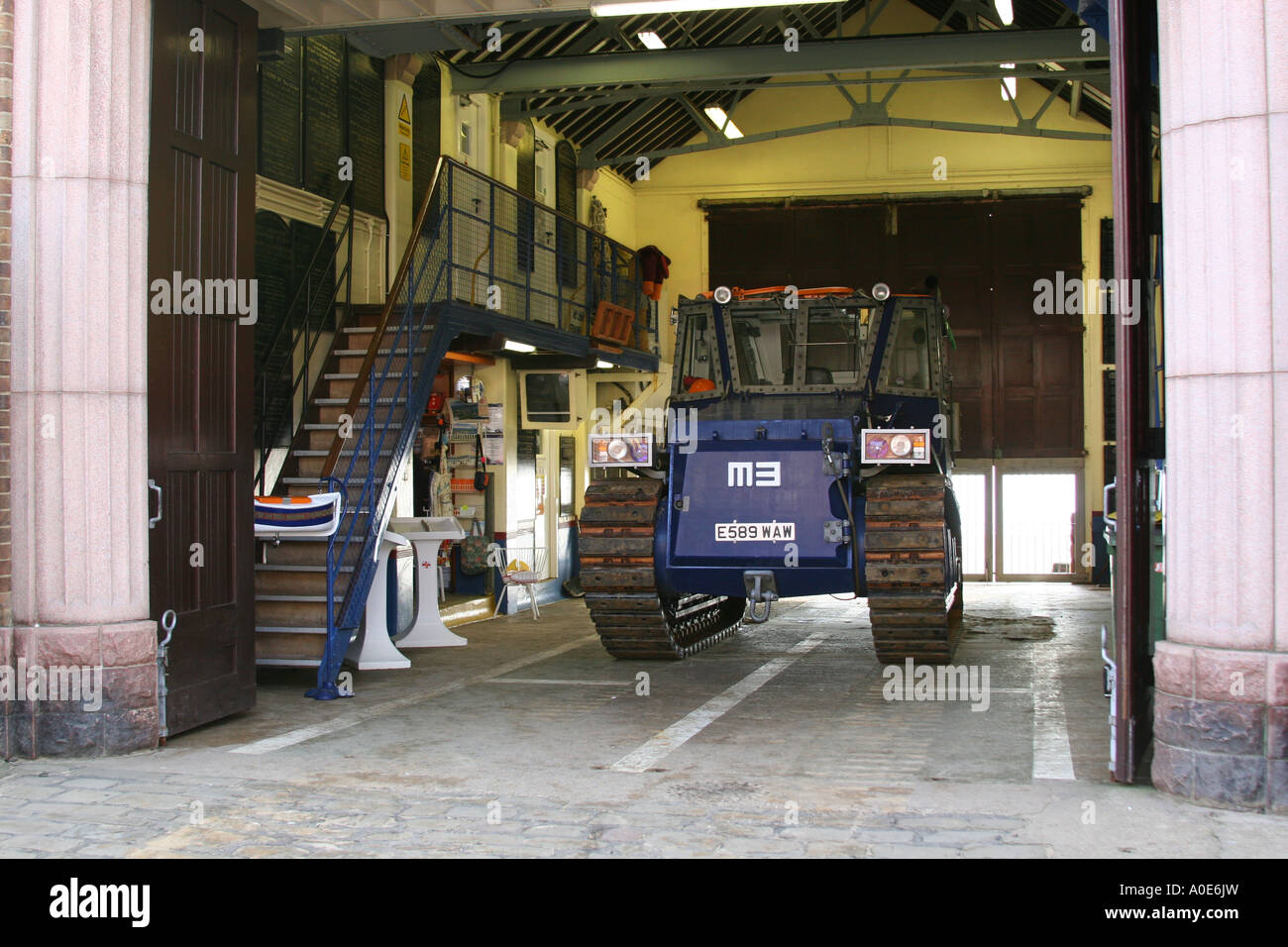 Empty lifeboat house with tracked diesel vehicle for moving lifeboat on ...