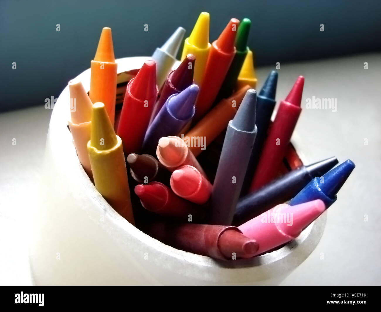 crayons of different colors inside a white cup Stock Photo - Alamy