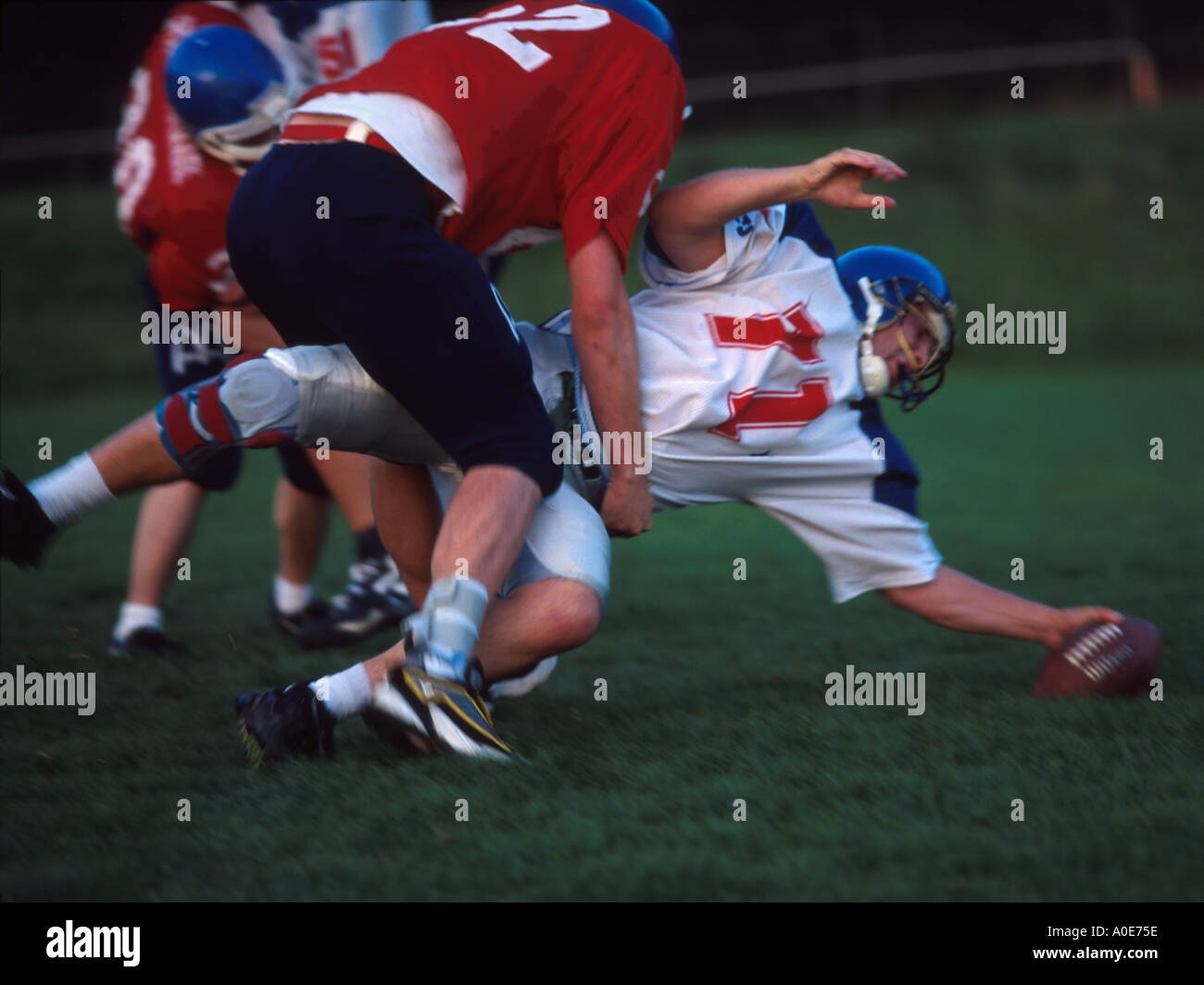 American Football young men playing football Stock Photo - Alamy