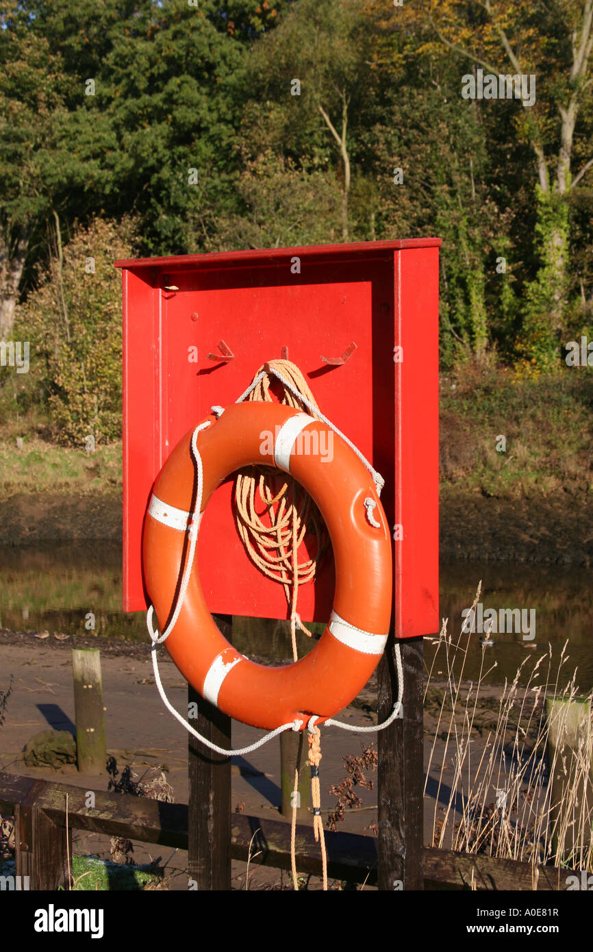 Bright red life saver in river side mount Stock Photo - Alamy