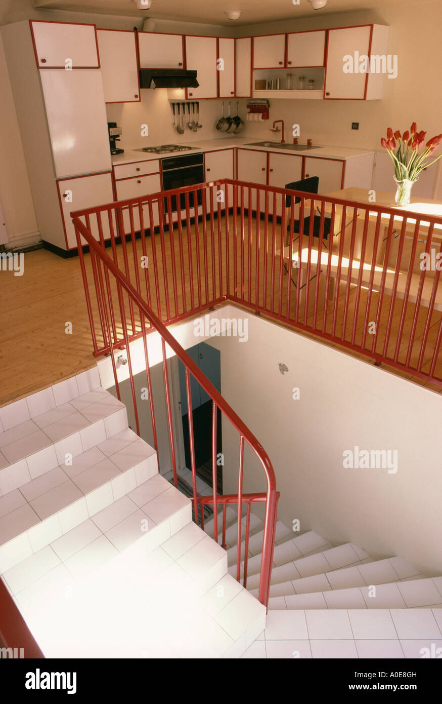 White tiled staircase to compact modern kitchen dining room on landing ...