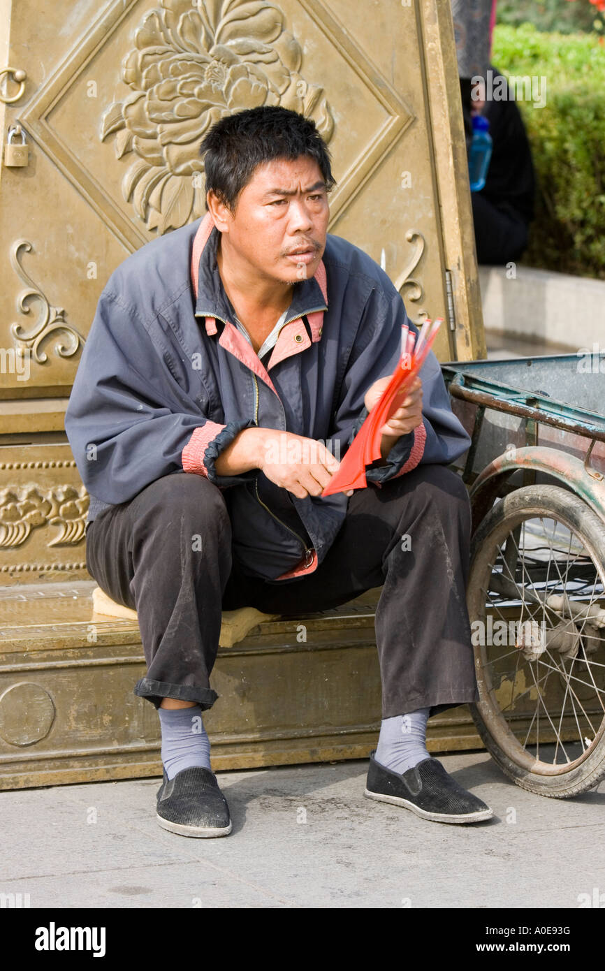 Seated man- Tienanmen Square Beijing Stock Photo - Alamy