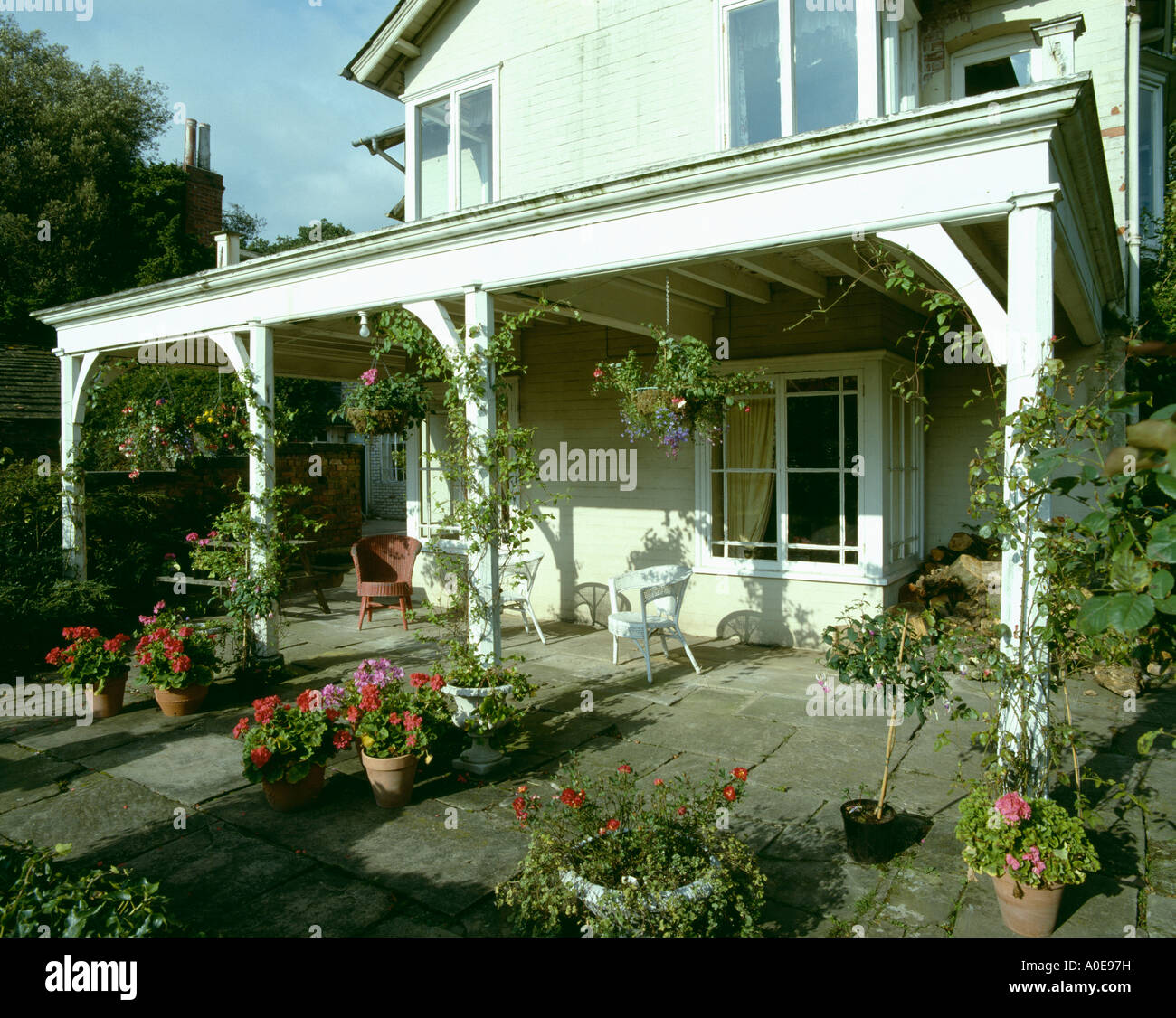 Flowering plants in pots on veranda of traditional house Stock Photo ...