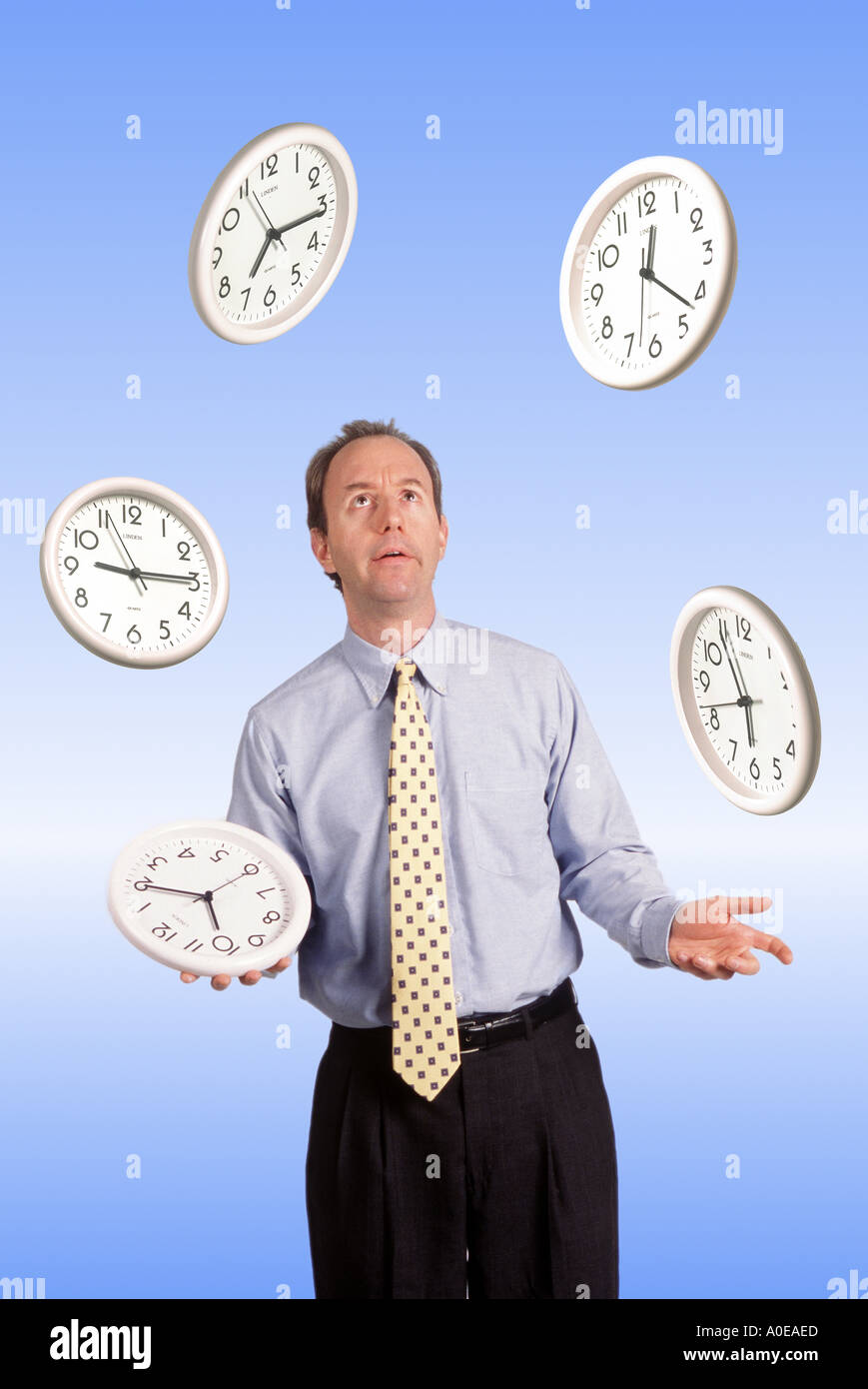 Business man juggling time Stock Photo - Alamy